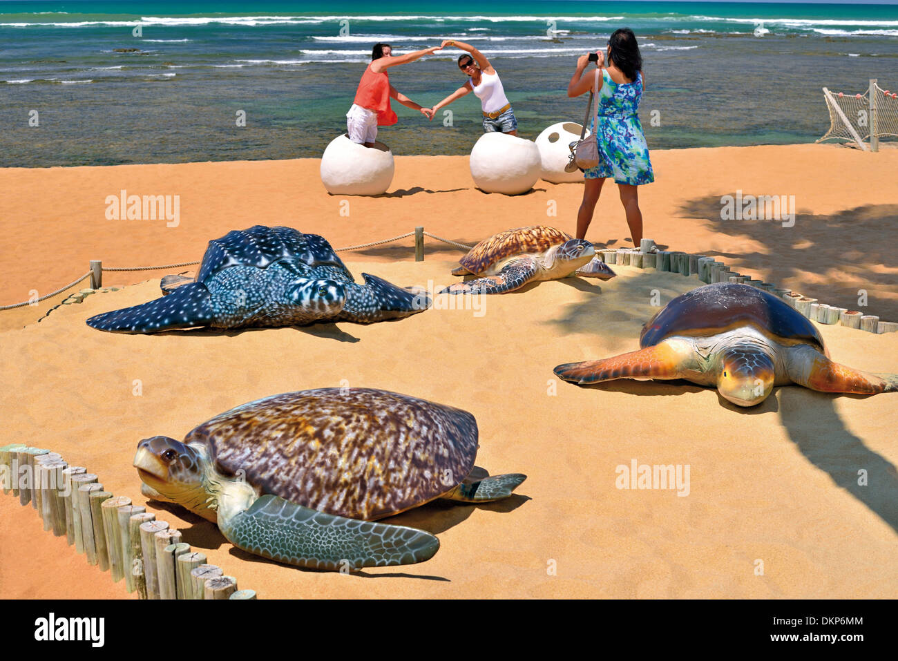 Brazil, Bahia: Tourists posing for snapshot with model sea turtle eggs ...