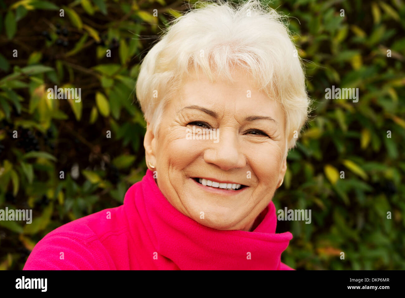 Portrait of a cheerful old lady over green background. Outdoor Stock ...