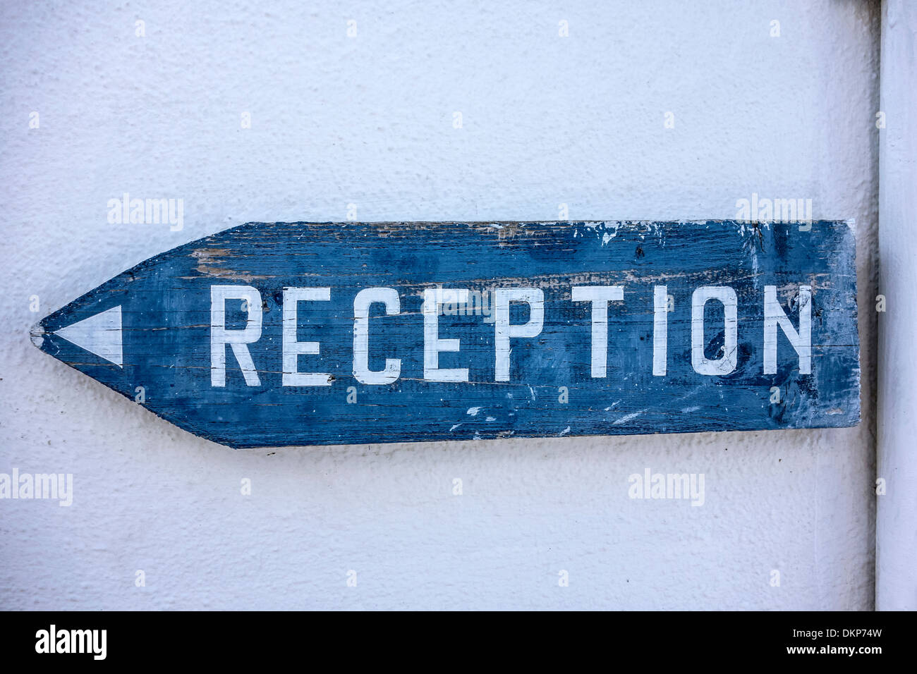 Reception Sign on white wall Stock Photo - Alamy