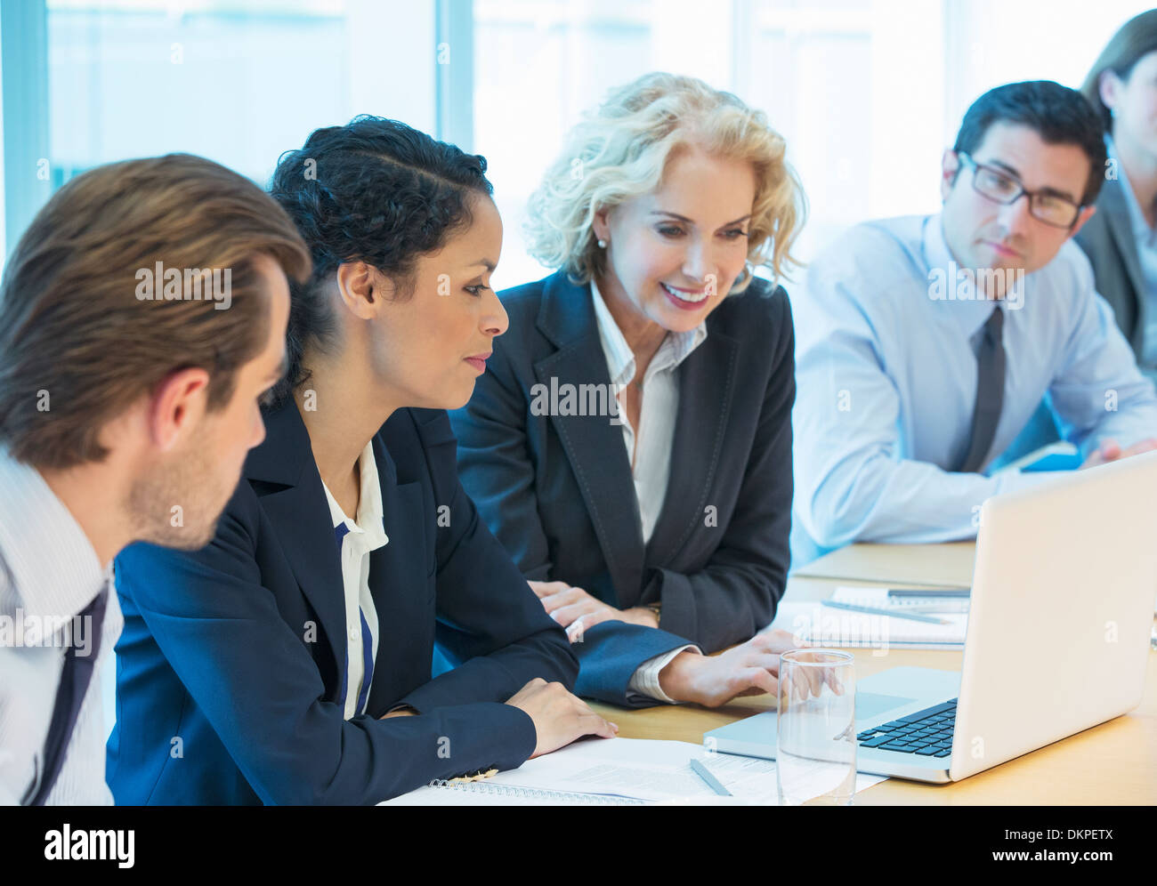 Business people using laptop in meeting Stock Photo - Alamy