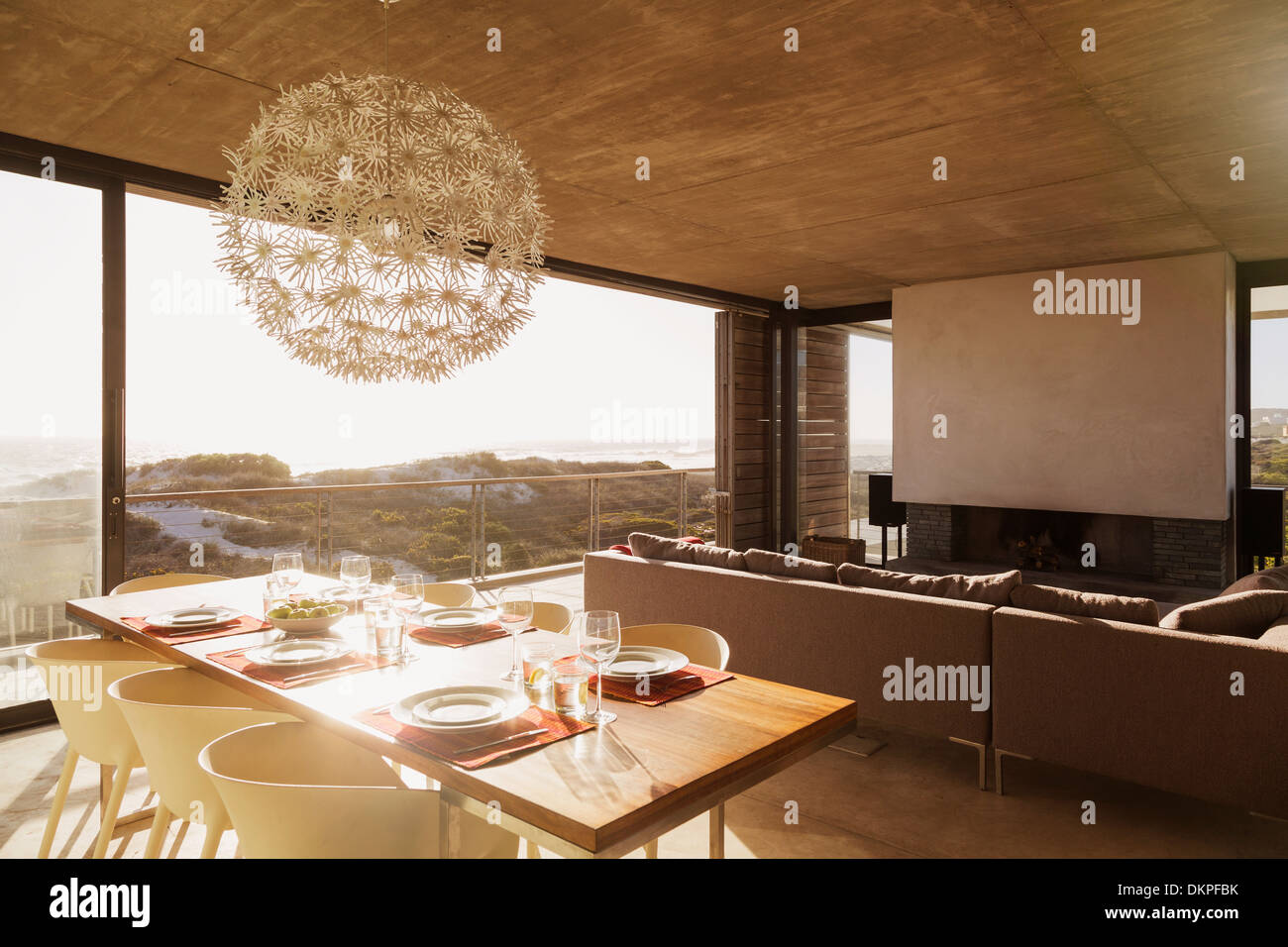Modern dining room and living room overlooking ocean Stock Photo - Alamy