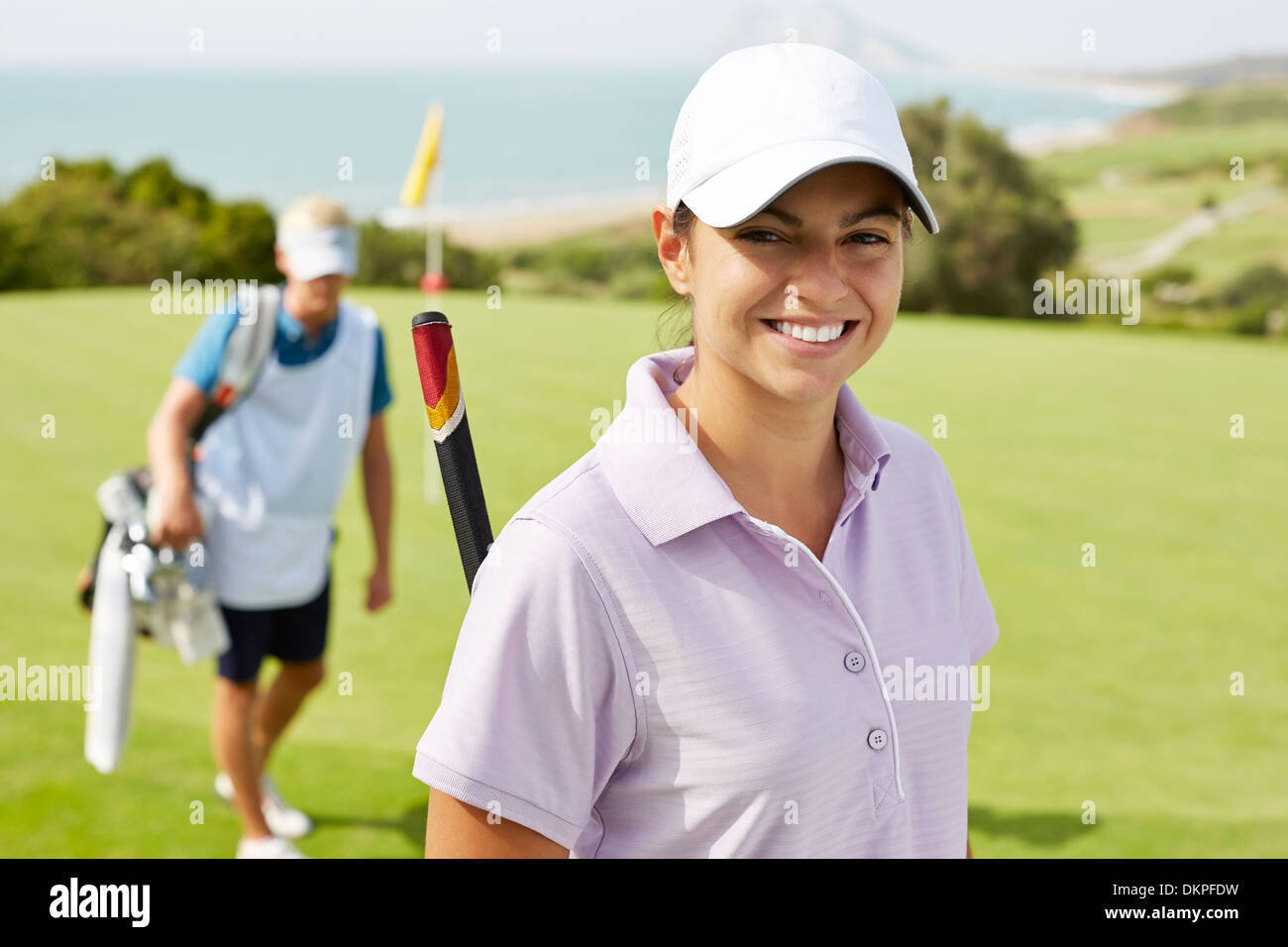 Smiling woman on golf course Stock Photo - Alamy
