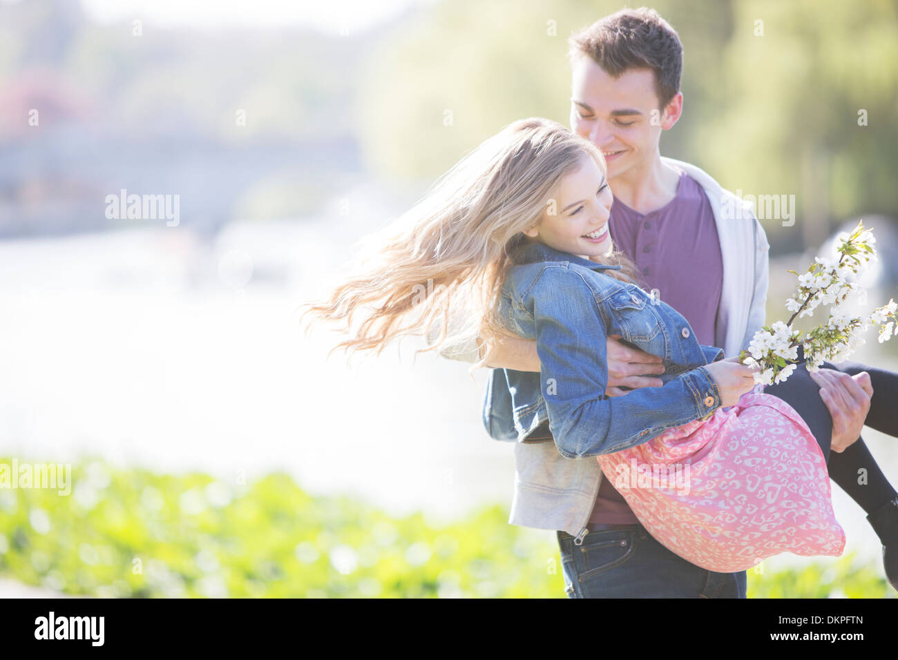 Man carrying girlfriend outdoors Stock Photo - Alamy