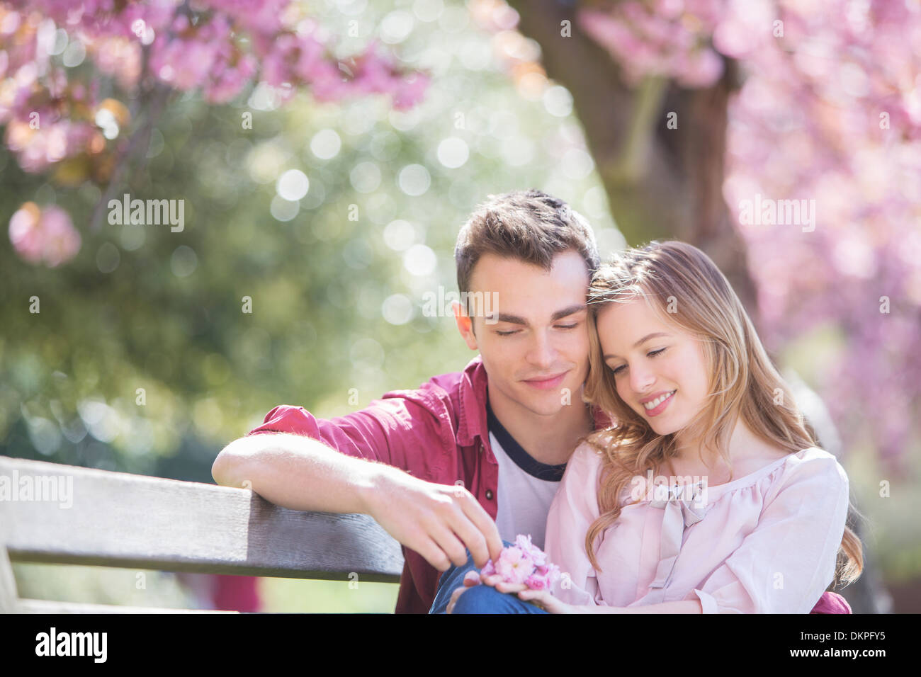 Couple hugging on park bench Stock Photo - Alamy