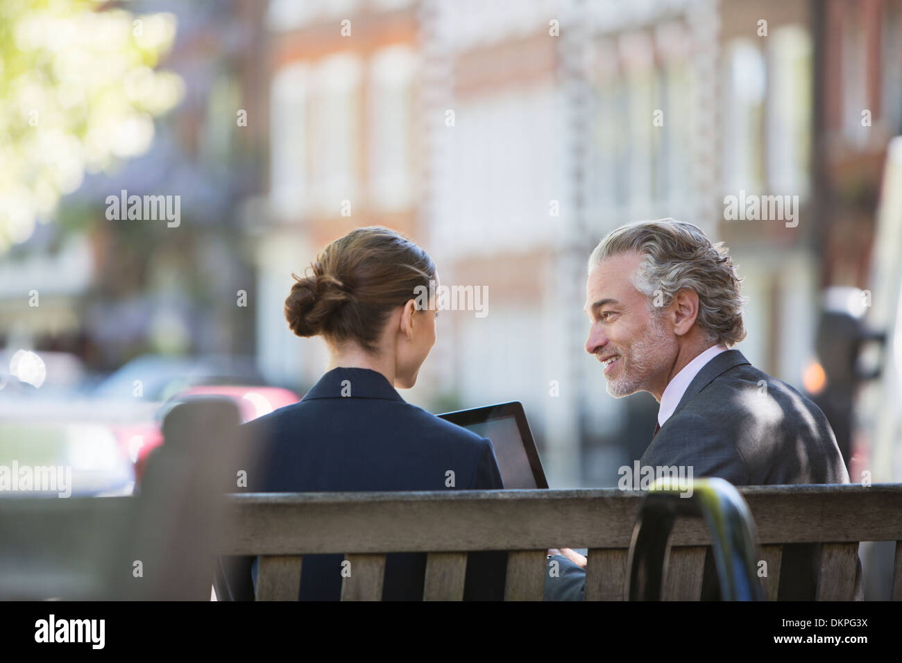 Business people talking on urban bench Stock Photo - Alamy