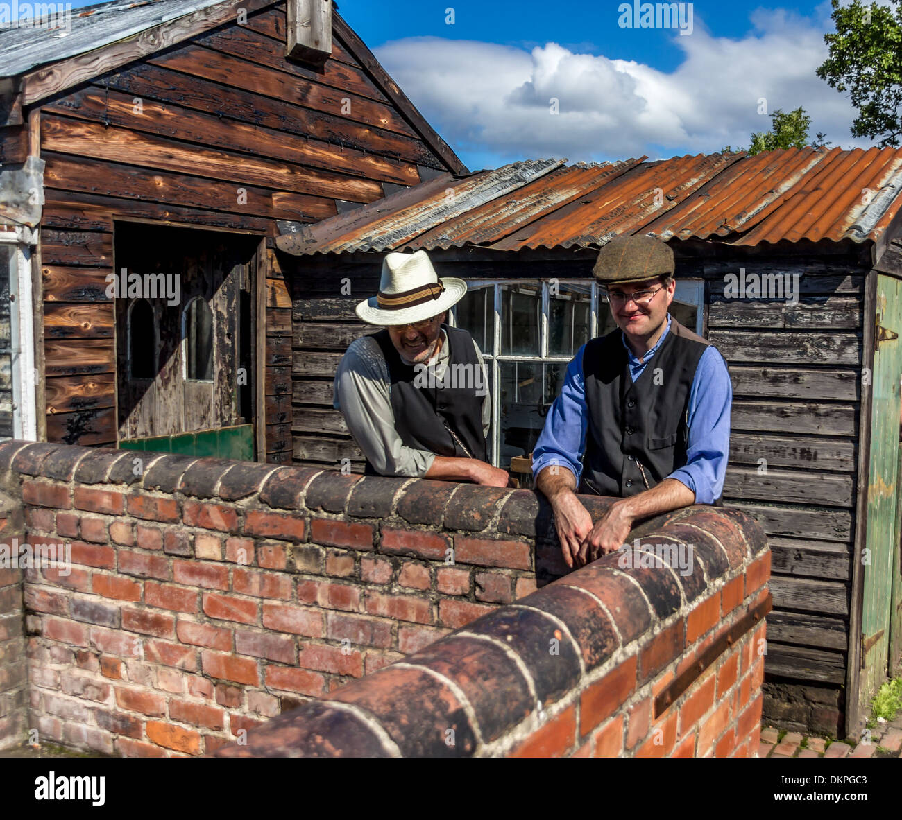 Two men looking over the wall and generally passing the time of day ...
