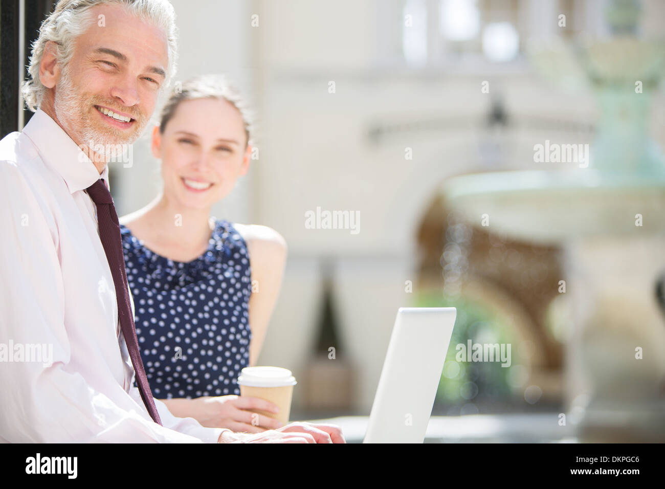 Business partner using laptop hi-res stock photography and images - Alamy