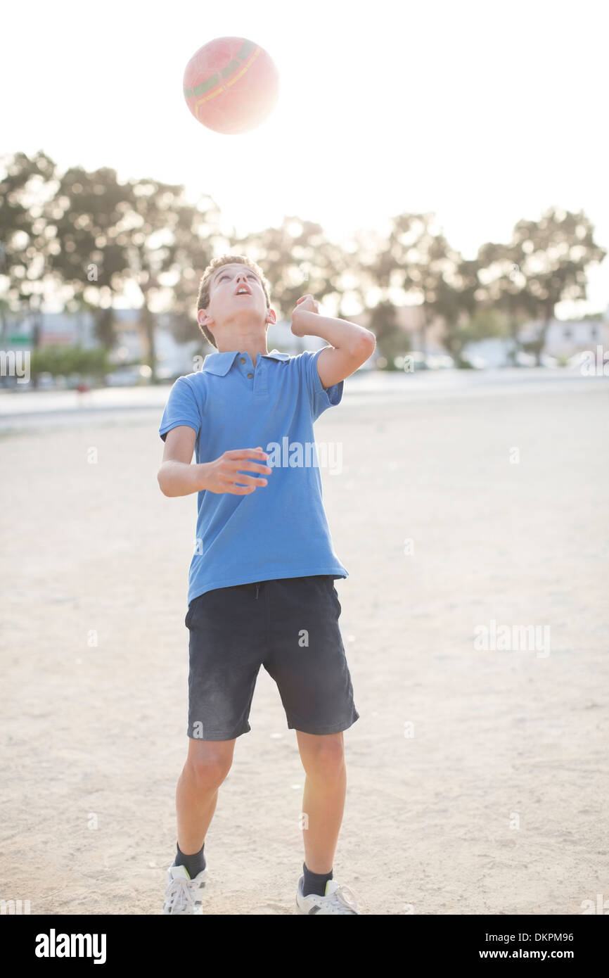 Boy heading soccer ball Stock Photo - Alamy