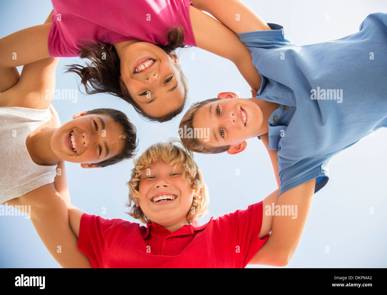 Children smiling in huddle outdoors Stock Photo - Alamy