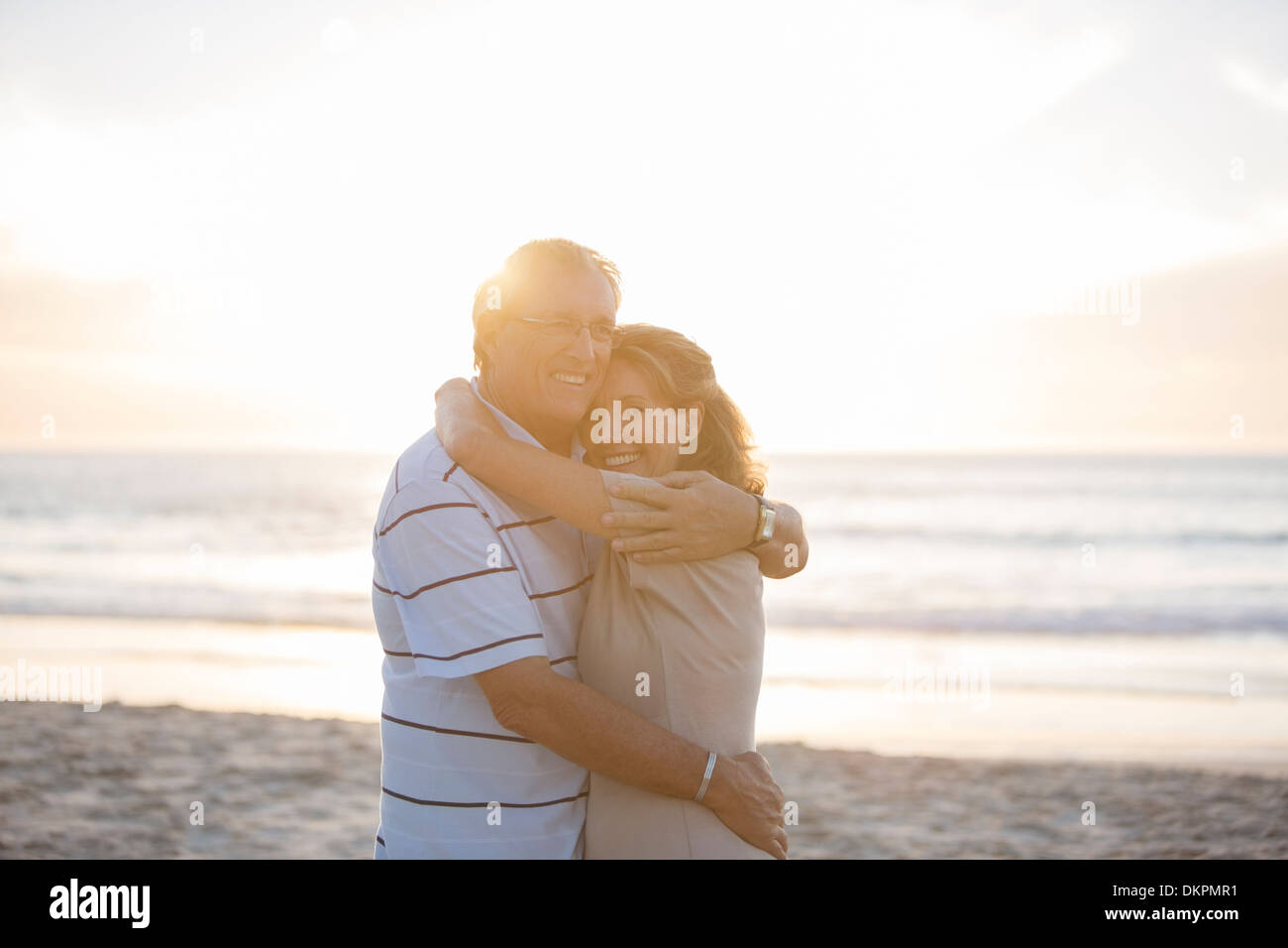 Couple hugging on shoreline hi-res stock photography and images - Alamy
