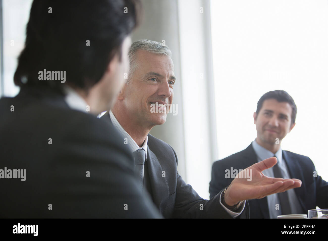 Businessman suit talking group three hi-res stock photography and ...