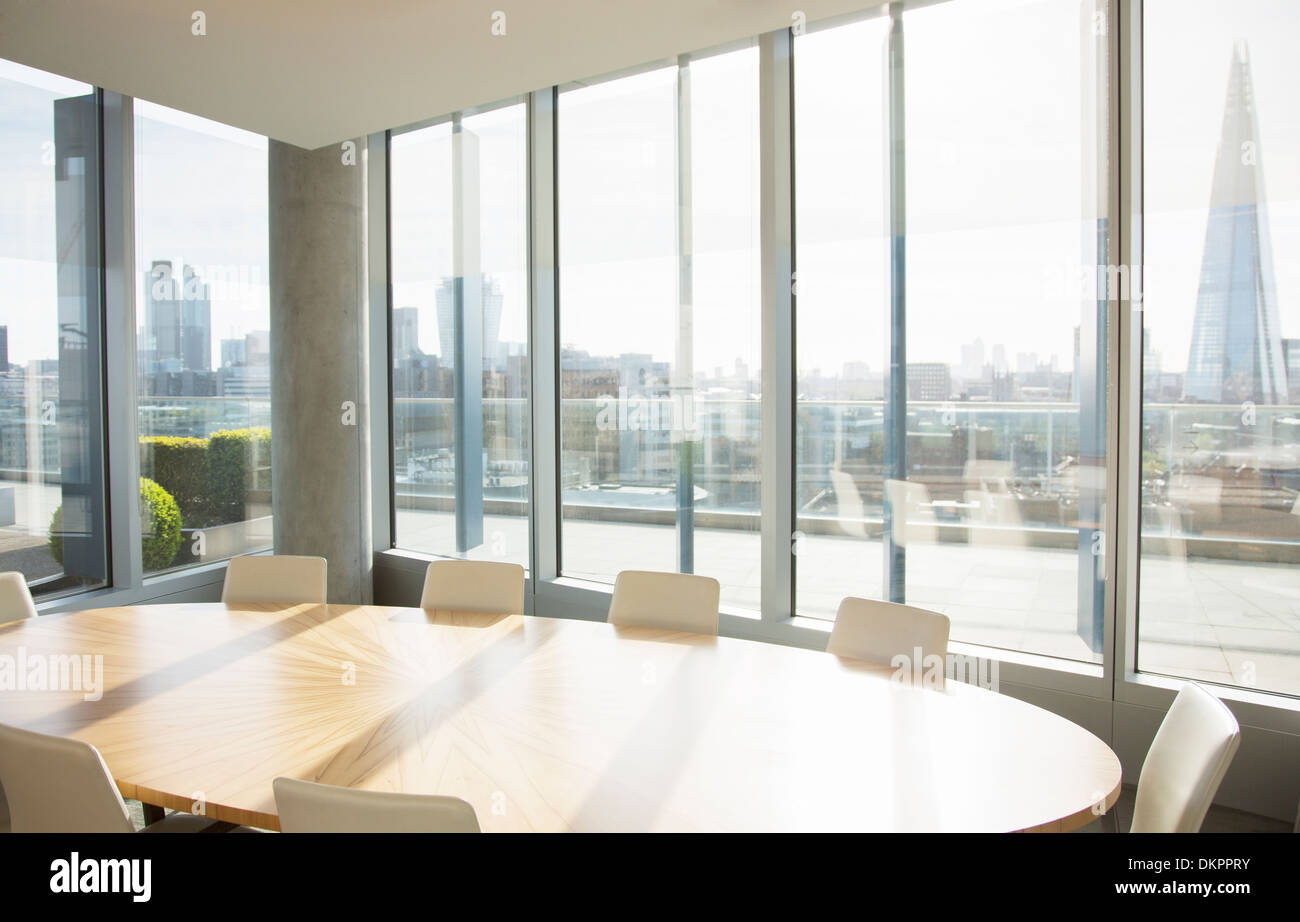 Empty conference room overlooking city Stock Photo - Alamy