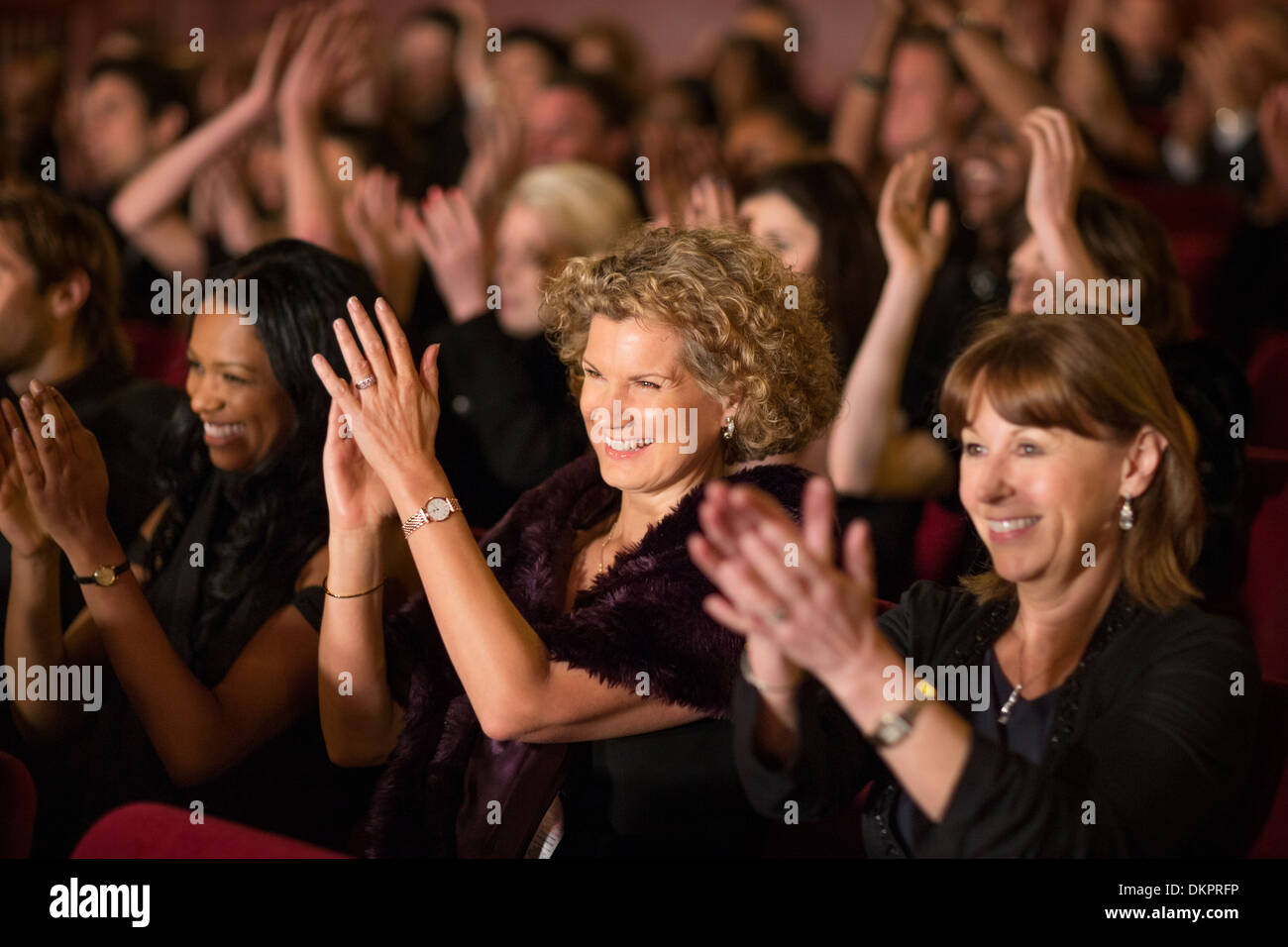 Clapping theater audience Stock Photo - Alamy