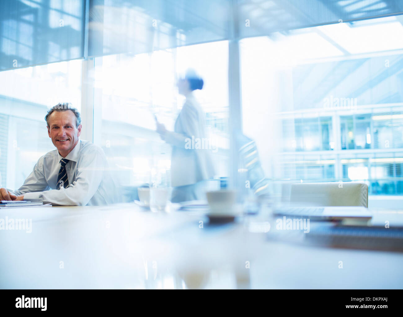 Businessman sitting in conference room Stock Photo - Alamy