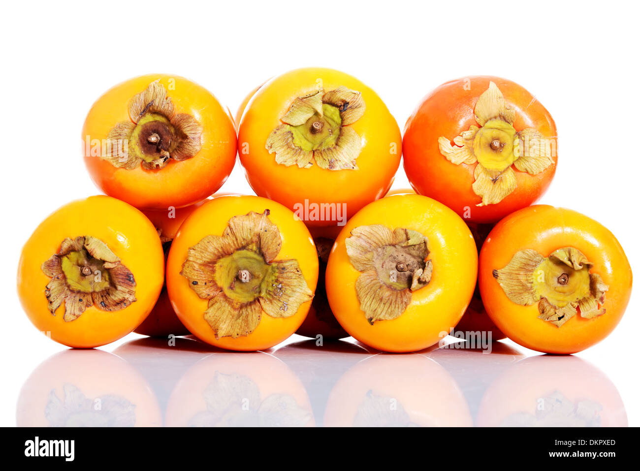 Composition of kaki fruits over white background Stock Photo - Alamy