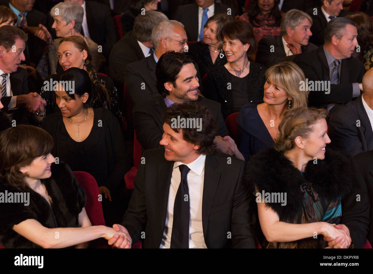 Theater audience handshaking Stock Photo - Alamy