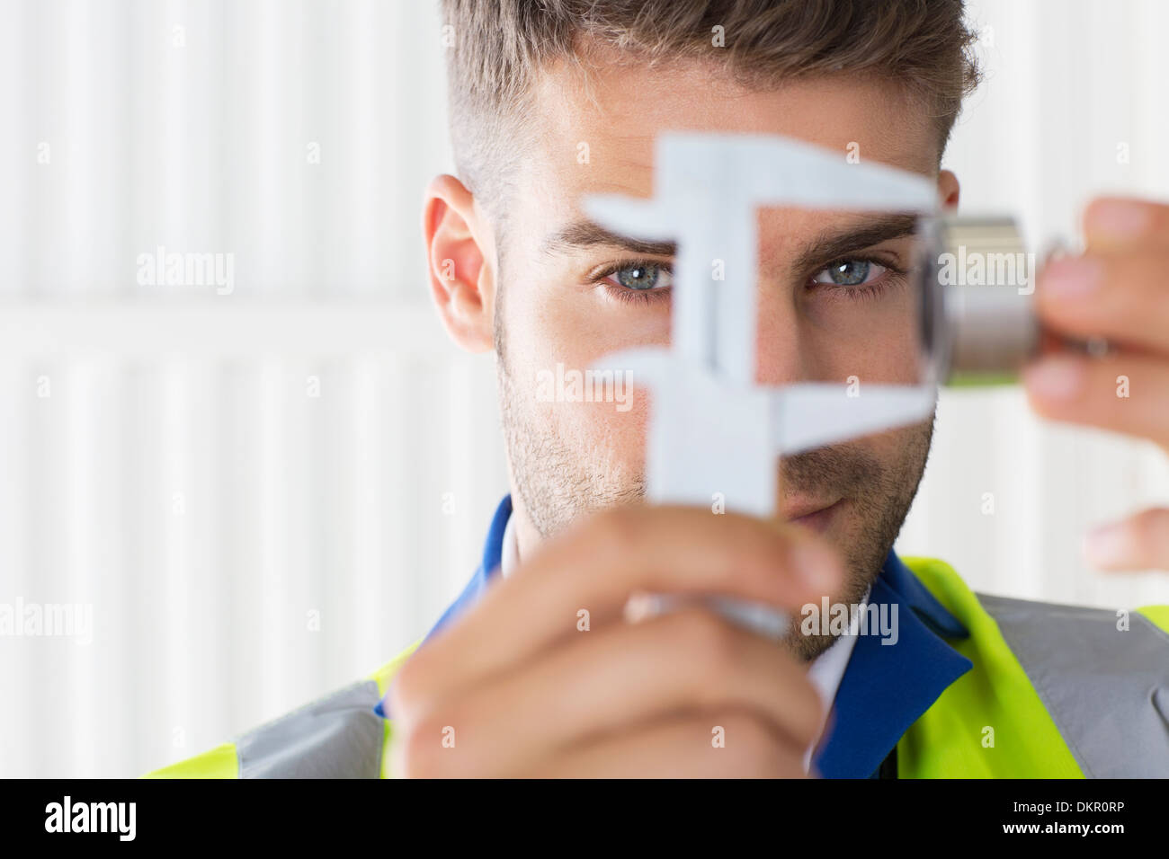 Worker using calipers in factory Stock Photo - Alamy