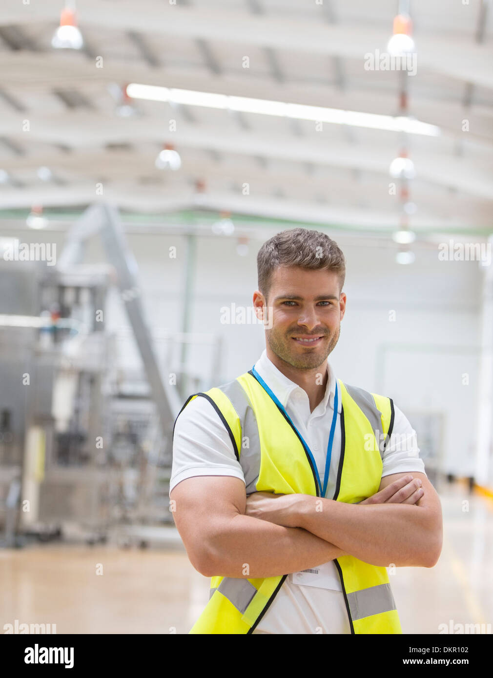 Worker smiling in factory Stock Photo - Alamy