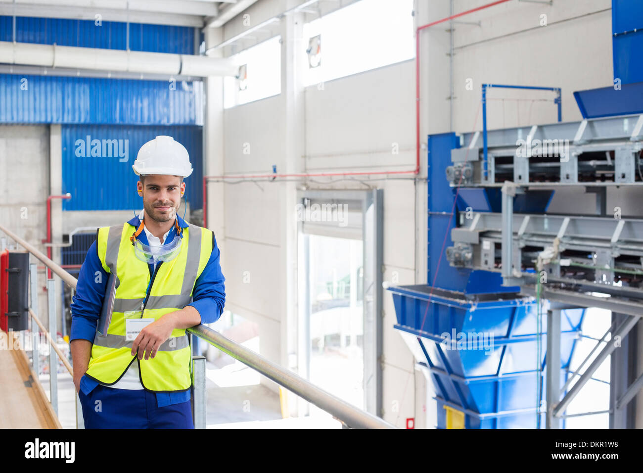 Worker smiling in factory Stock Photo - Alamy