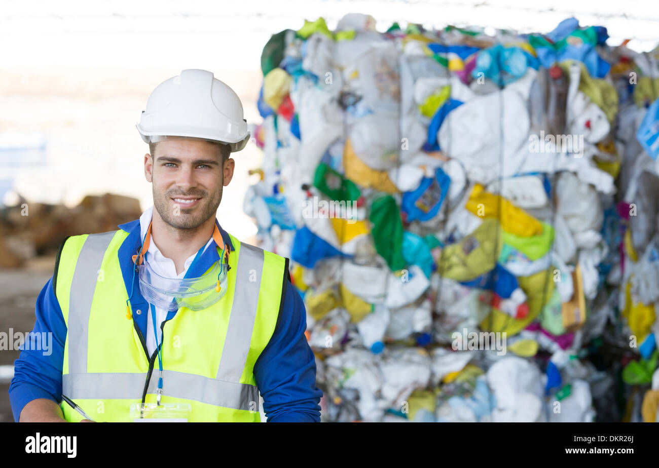 Worker smiling in recycling center Stock Photo - Alamy