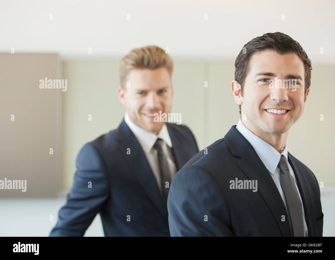 Businessmen smiling in office Stock Photo - Alamy