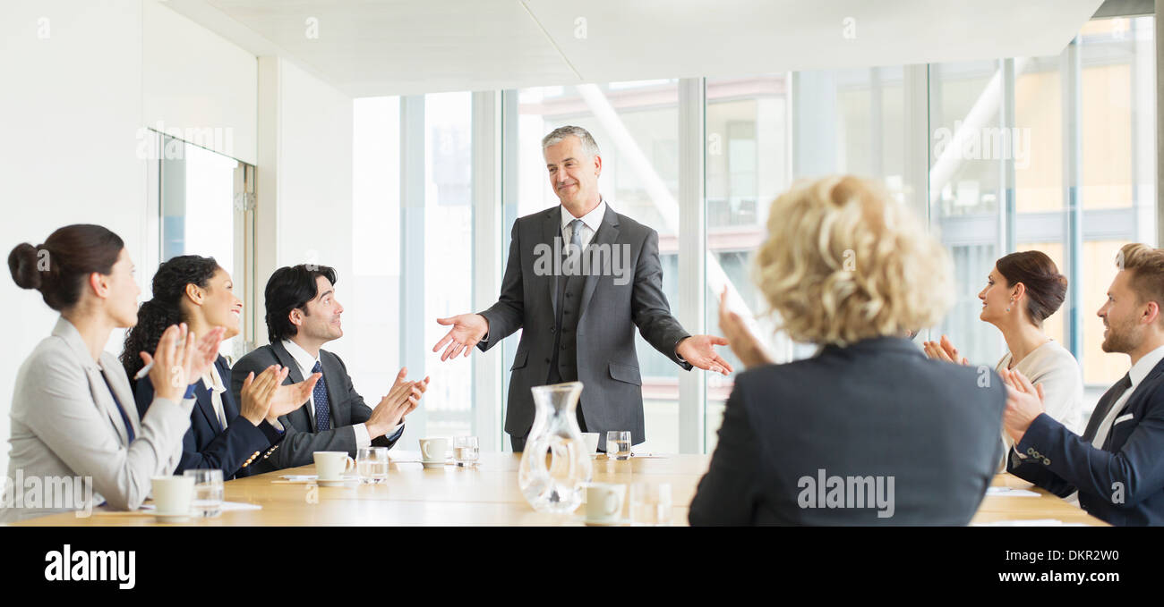Business people clapping in meeting Stock Photo - Alamy