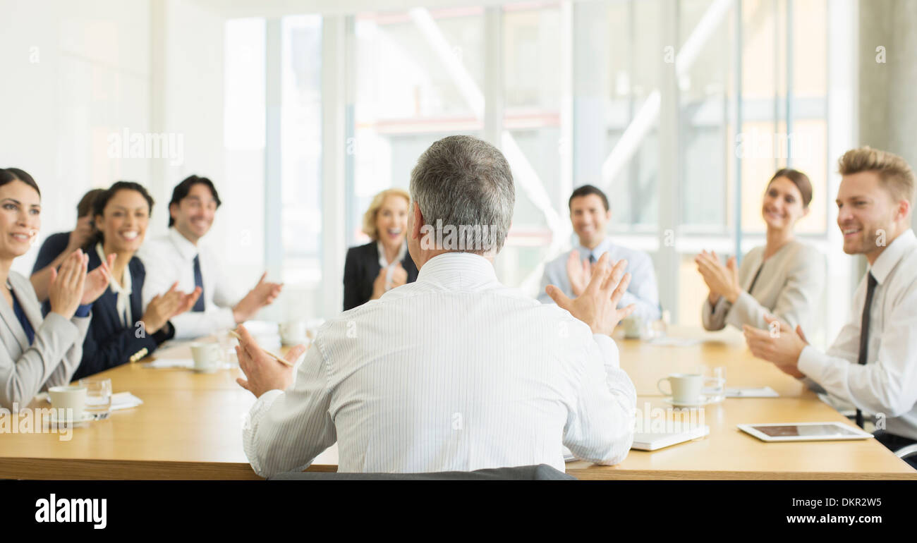 Business people clapping in meeting Stock Photo - Alamy