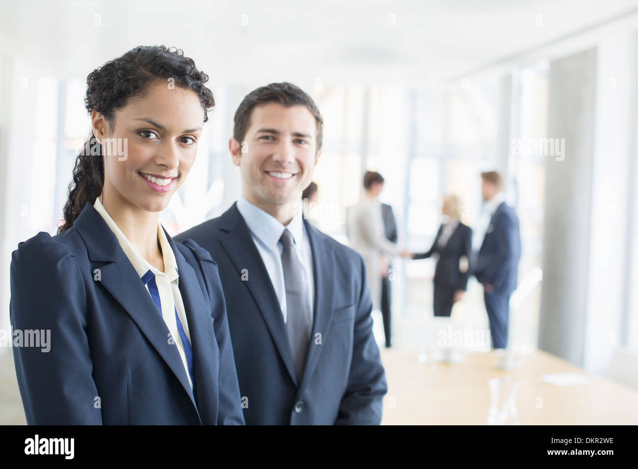 Business people smiling in office Stock Photo - Alamy