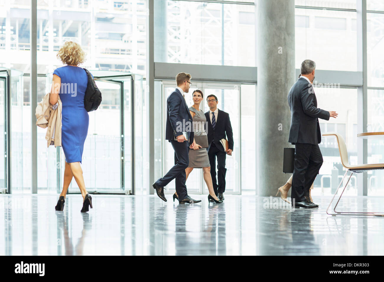 Business people walking in office lobby Stock Photo - Alamy