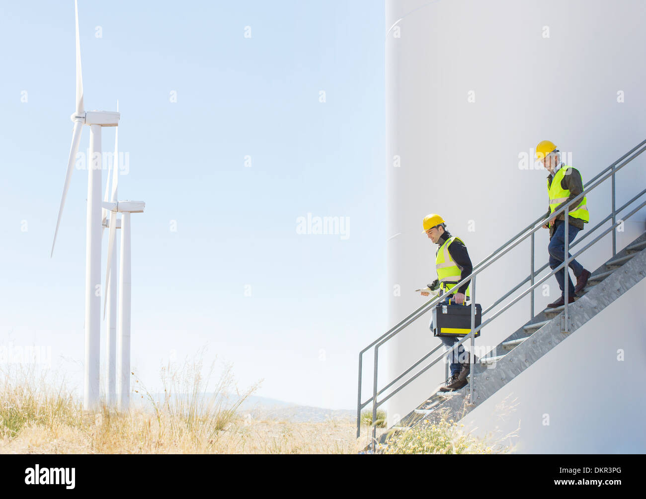 Workers on wind turbine in rural landscape Stock Photo - Alamy