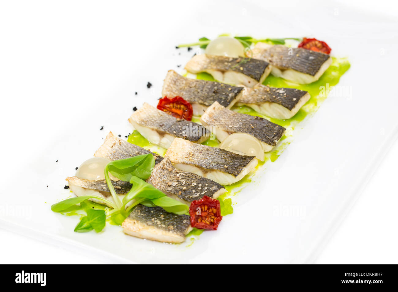 Baked black cod fish on a white background Stock Photo - Alamy