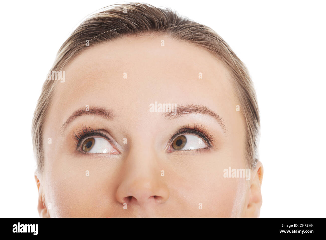 Woman's face, cut out composition. She's looking up. Isolated on white ...
