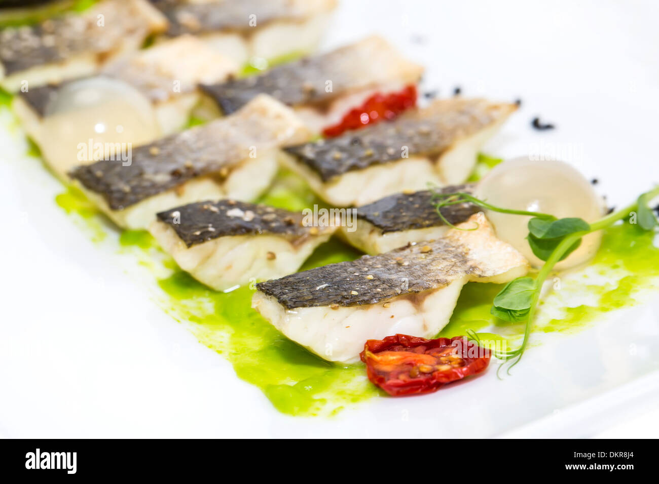Baked black cod fish on a white background Stock Photo - Alamy