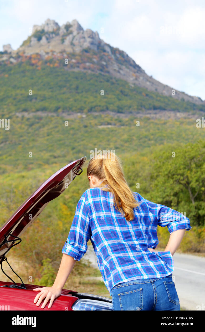 Woman looking under hood car hi-res stock photography and images - Alamy
