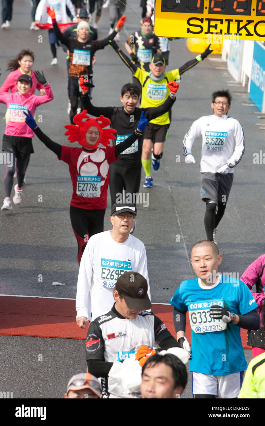 Feb 28, 2010 - Tokyo, Japan - Runners wave their hands in the air as ...