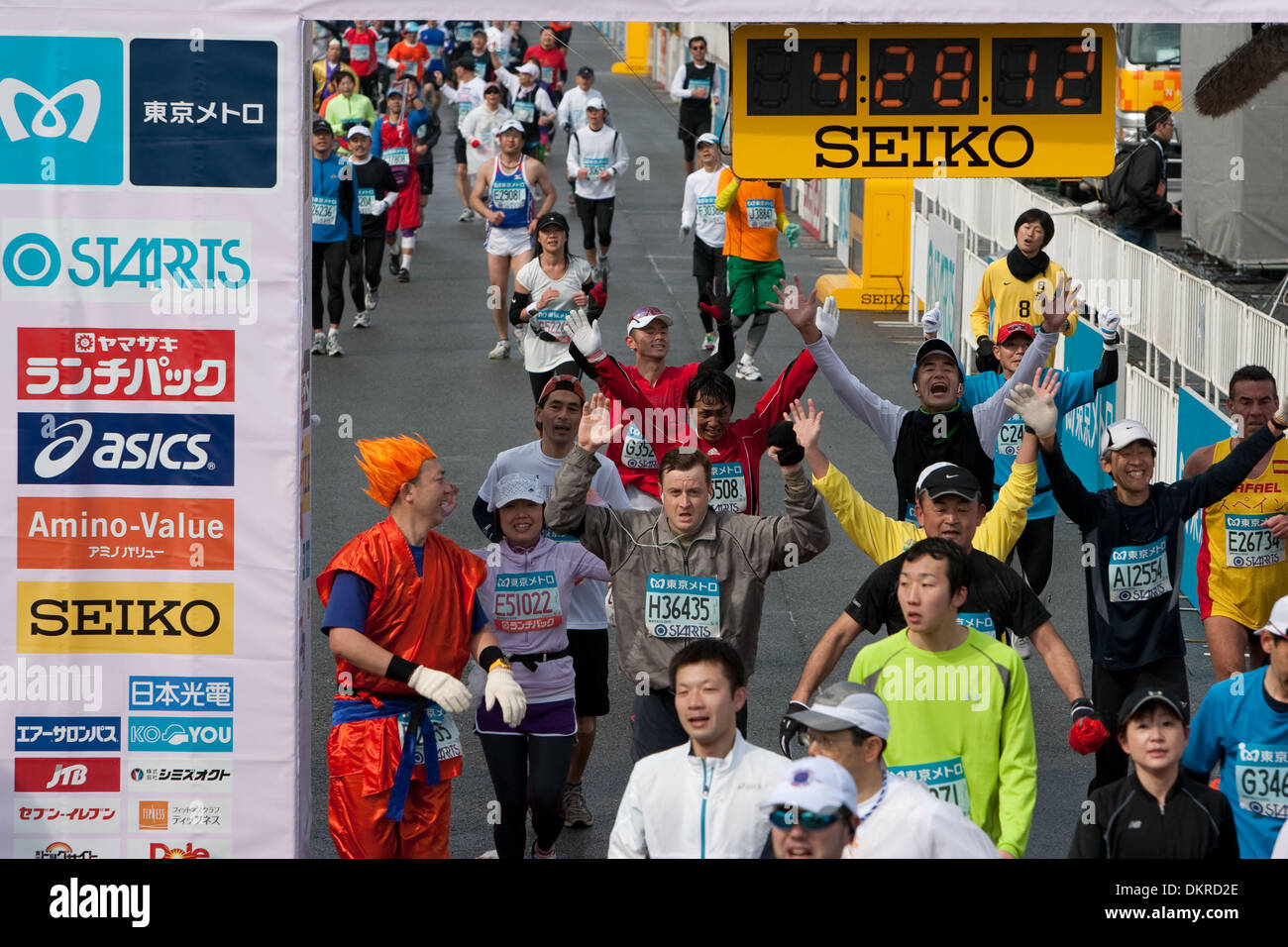 Feb 28, 2010 - Tokyo, Japan - Runners wave their hands in the air as ...