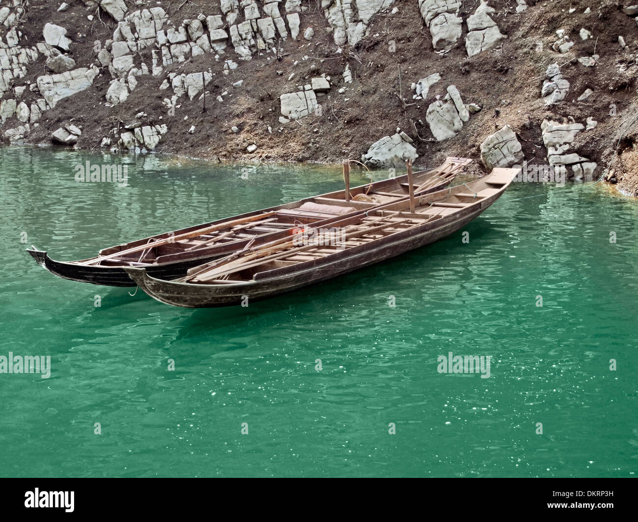 two traditional rowboats anchoring waterside at River Shennong Xi in ...