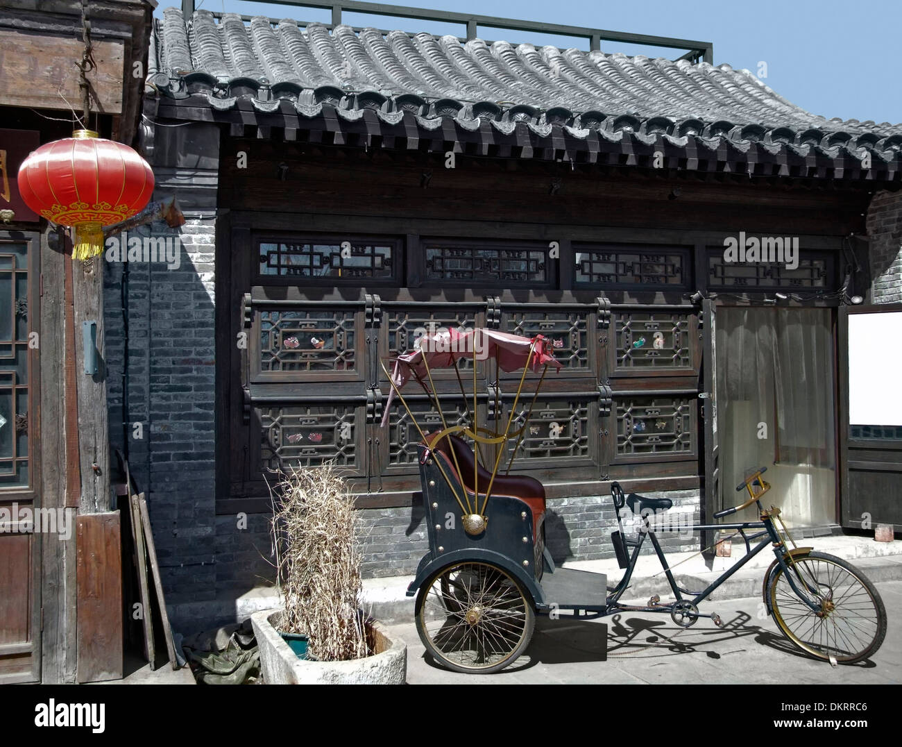 sunny illuminated pictorial detail in Beijing (China) with richshaw and ...