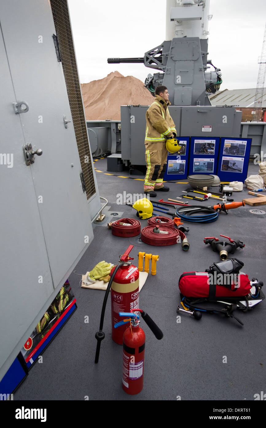 HMS Defender D36 Fireman displaying Fire Fighting Equipment on deck ...