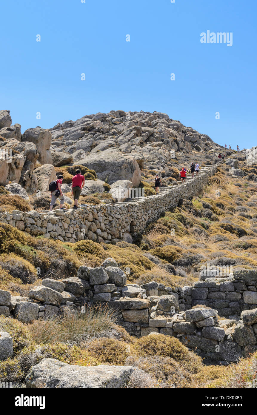 Tourists walking the stone steps up Mount Kynthos, Delos, Cyclades ...
