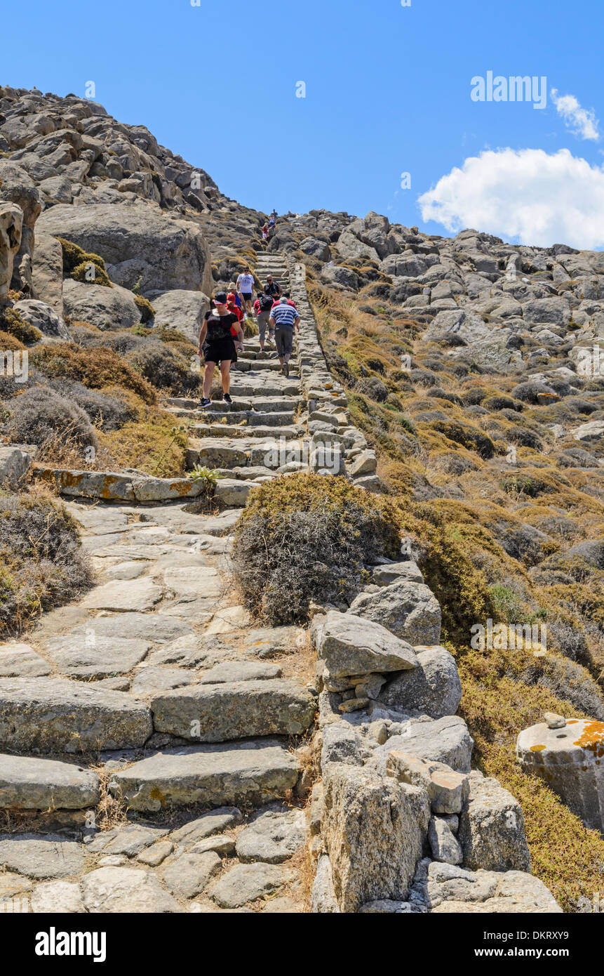 Tourists walking the stone steps up Mount Kynthos, Delos, Cyclades ...