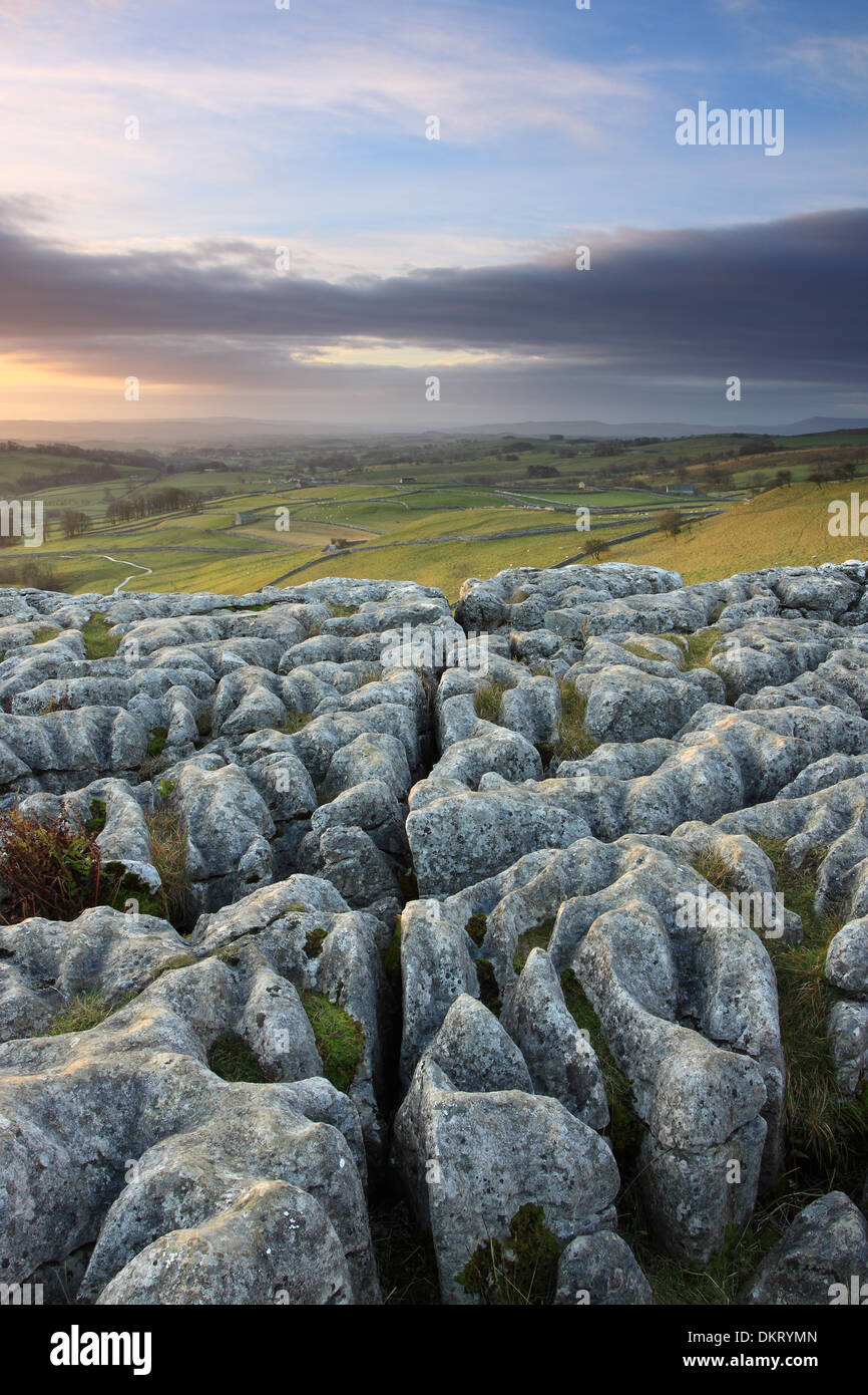 Sunrise over the weathered rocks of Malham Cove in the Yorkshire Dales ...