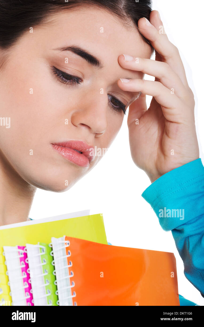 Portrait of young sad female student with workbook. Isolated on white ...