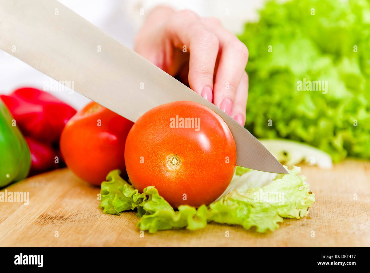 Woman cutting vegetables for a salad Stock Photo - Alamy