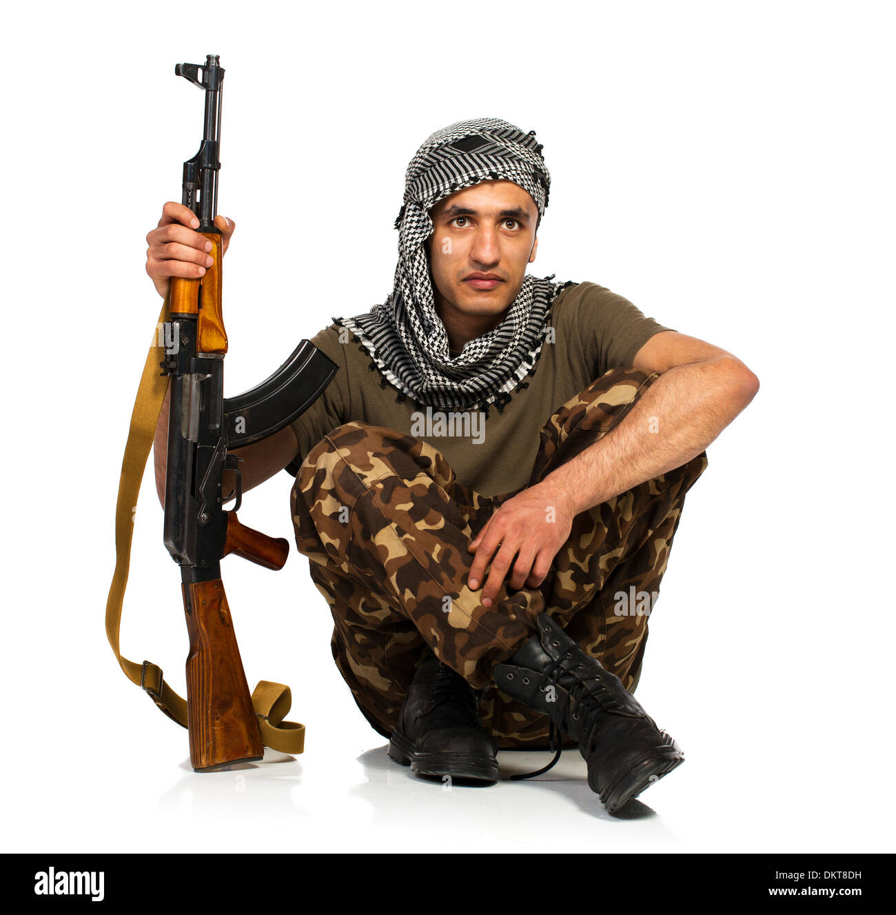 Arab nationality in camouflage suit and keffiyeh with automatic gun on ...