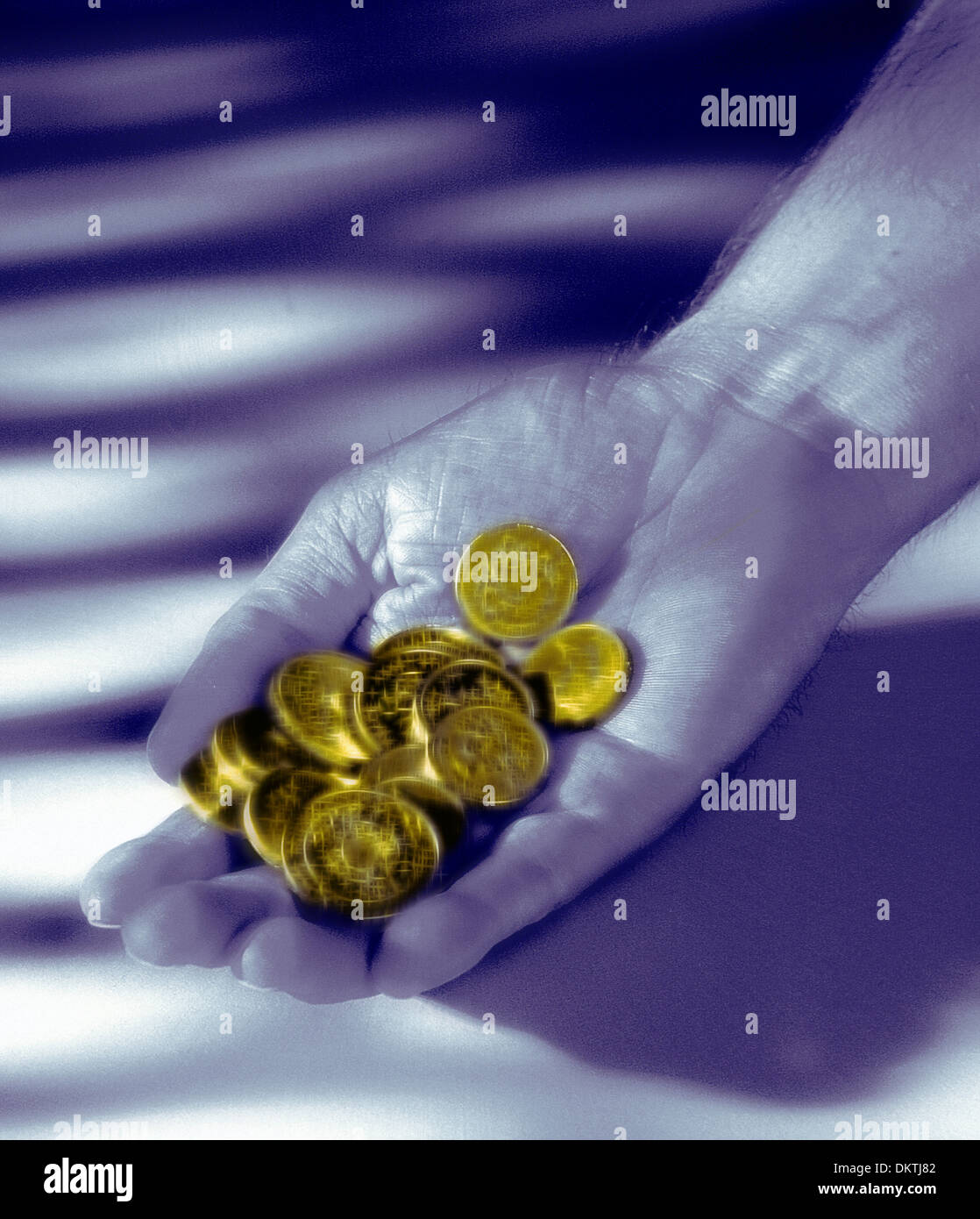 Hand holding gold coins Stock Photo - Alamy