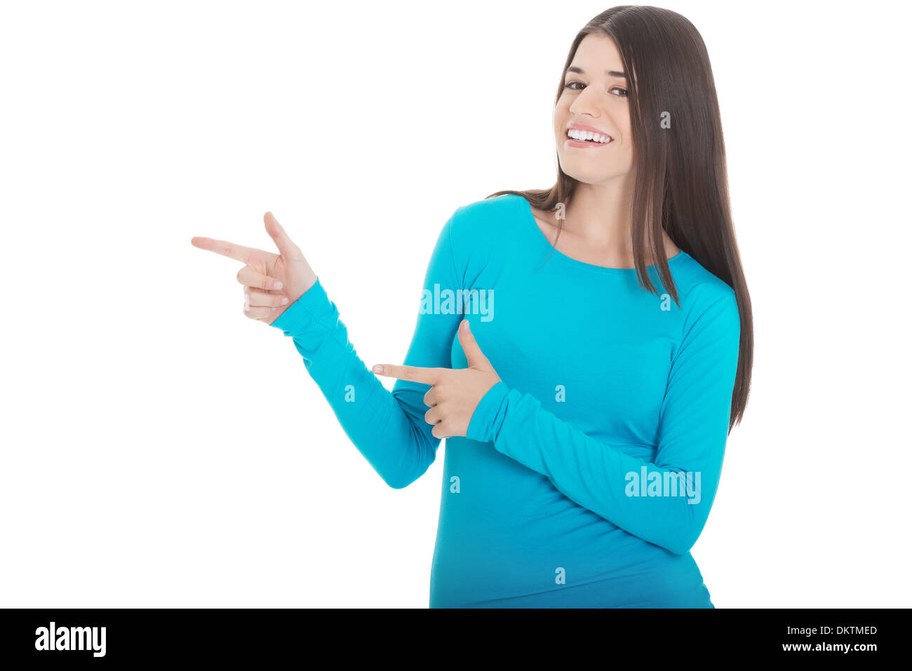 Beautiful casual woman pointing on copy space. Isolated on white Stock ...