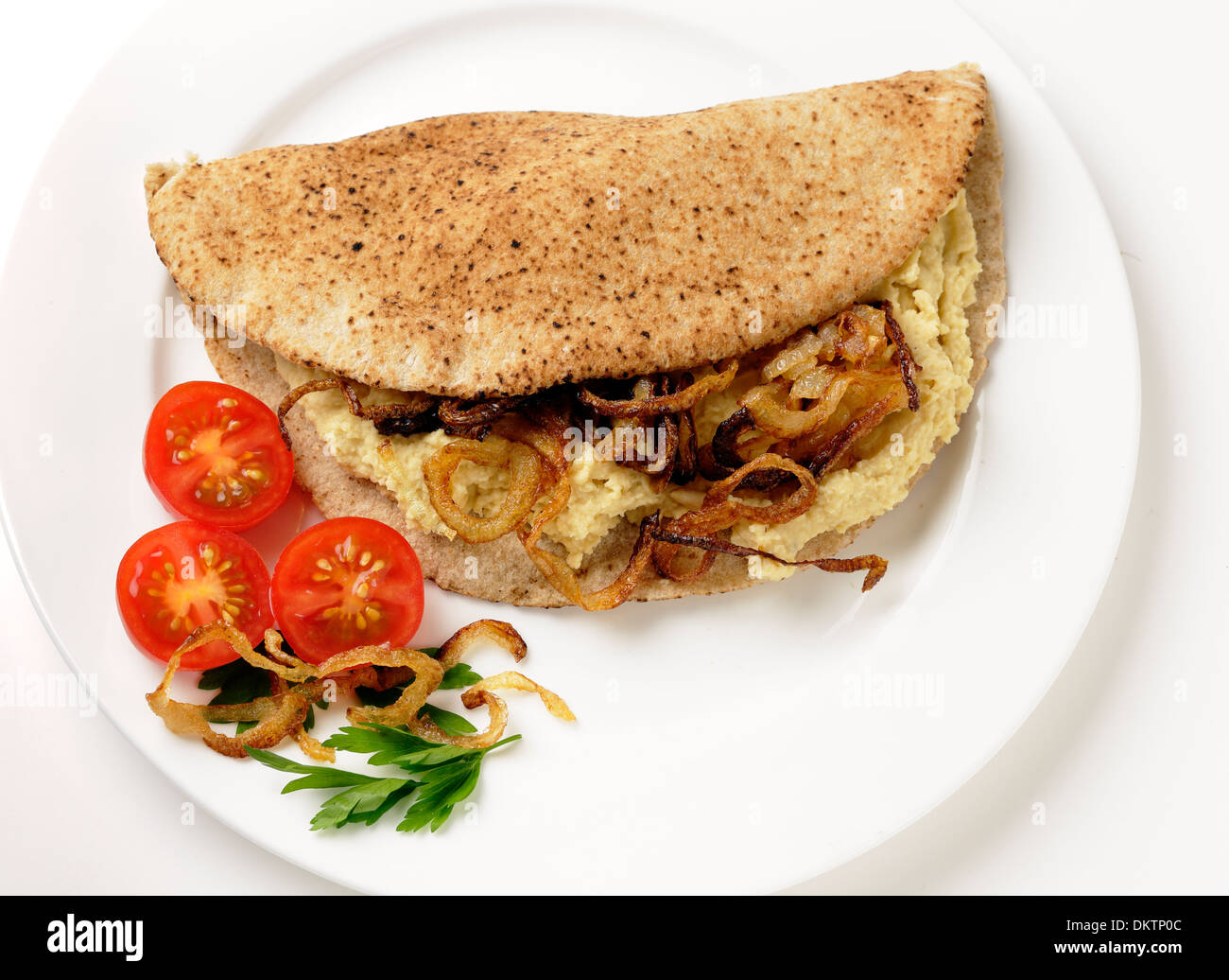 A pitta bread, or kubz, sandwich made with hummus and caramelised ...