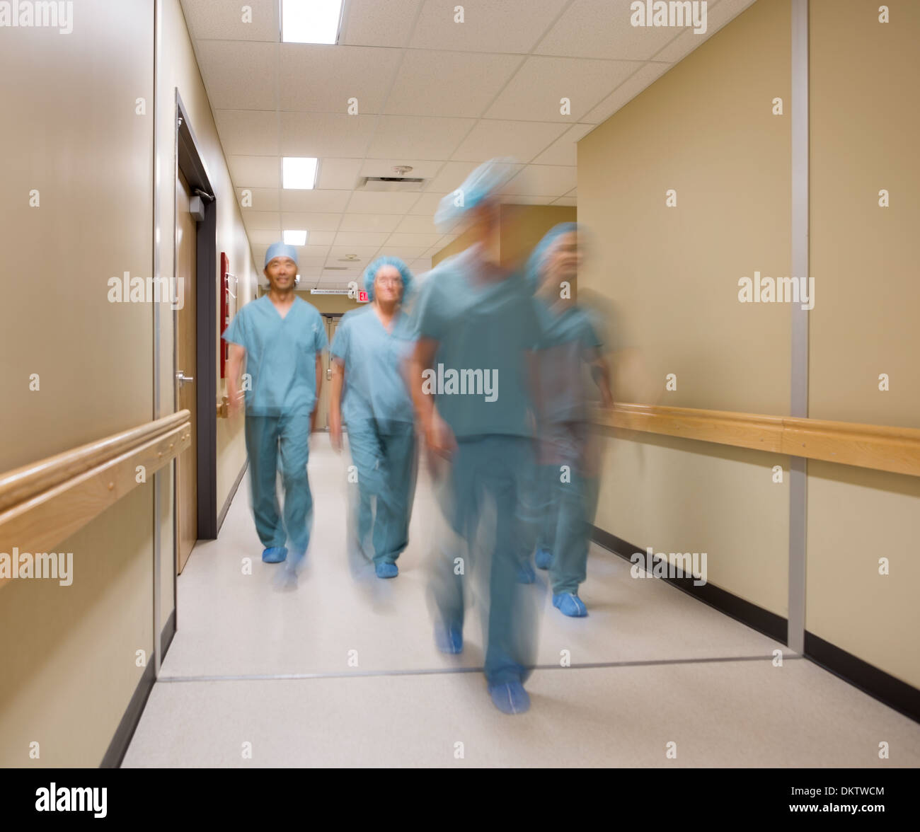 Medical Team Walking In Hospital Corridor Stock Photo - Alamy