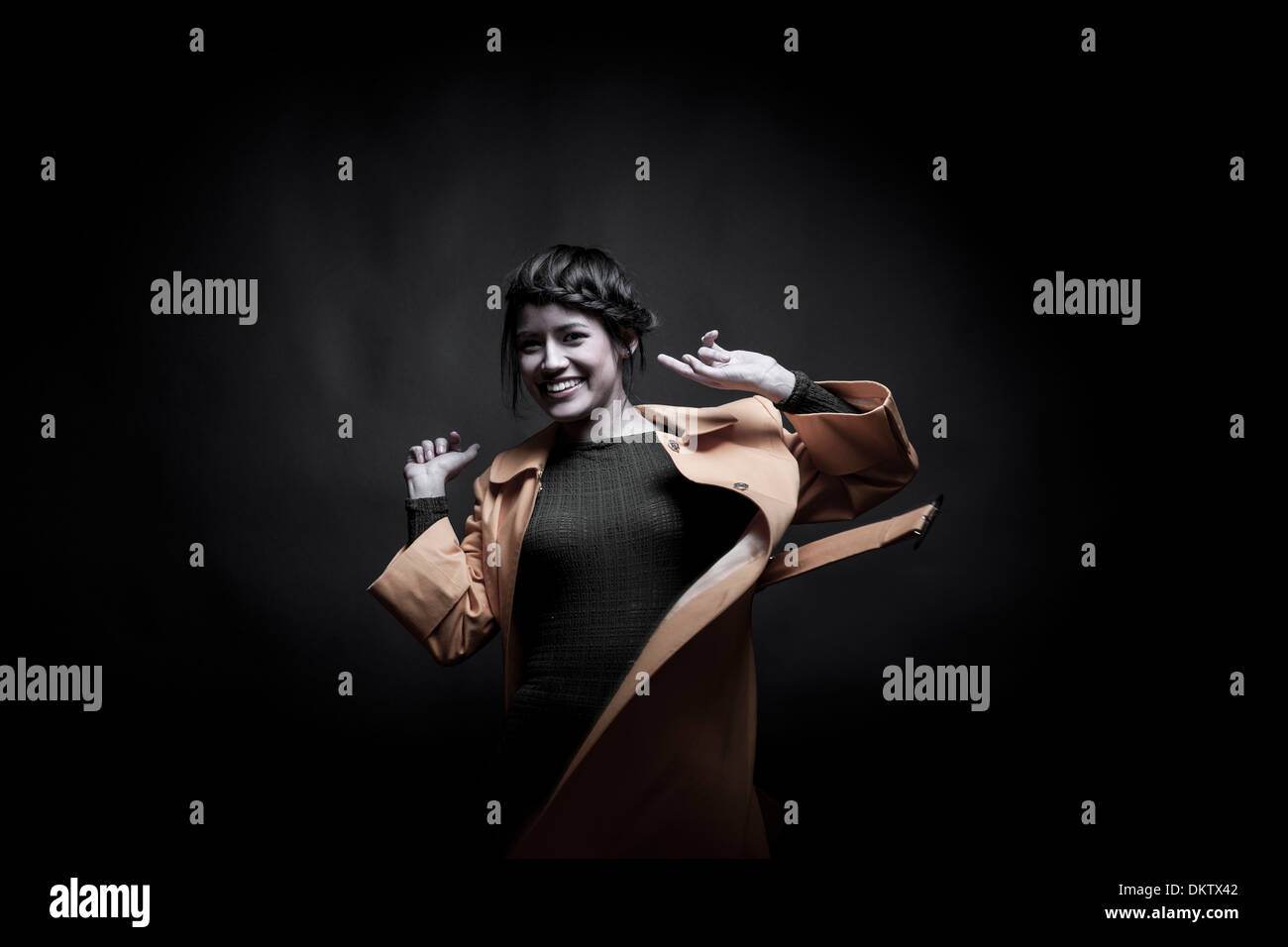 Studio portrait of a smiling young woman Stock Photo - Alamy